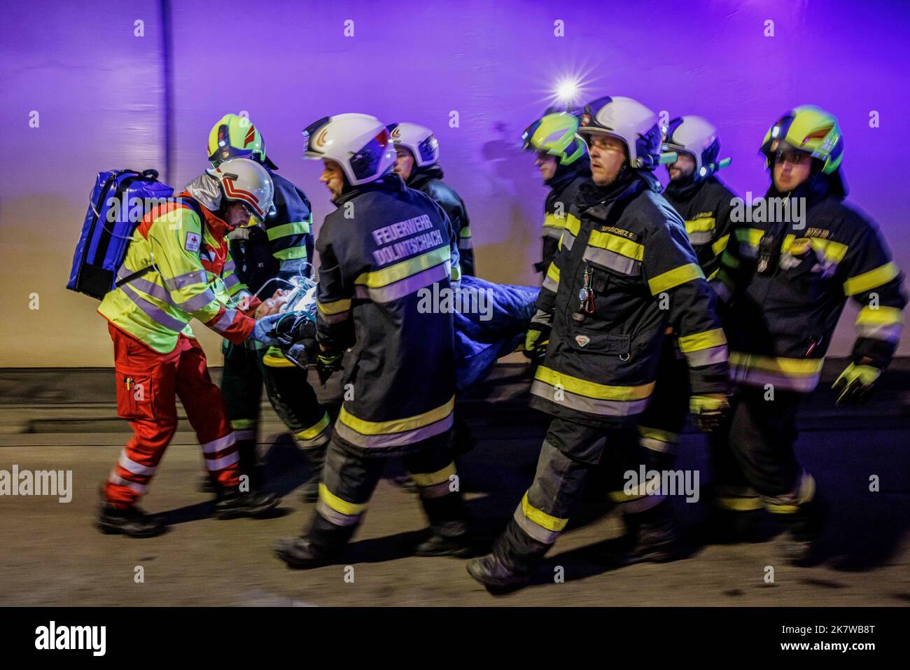 Austrian firemen and medical personnel carry an accident casualty away ...