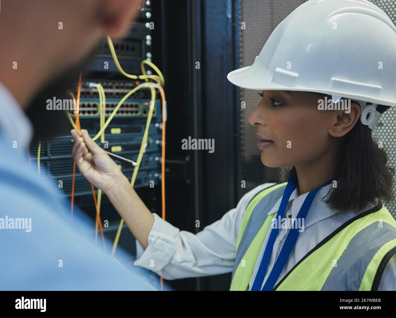 Here, let me show you how its done. two workers inspecting the ...