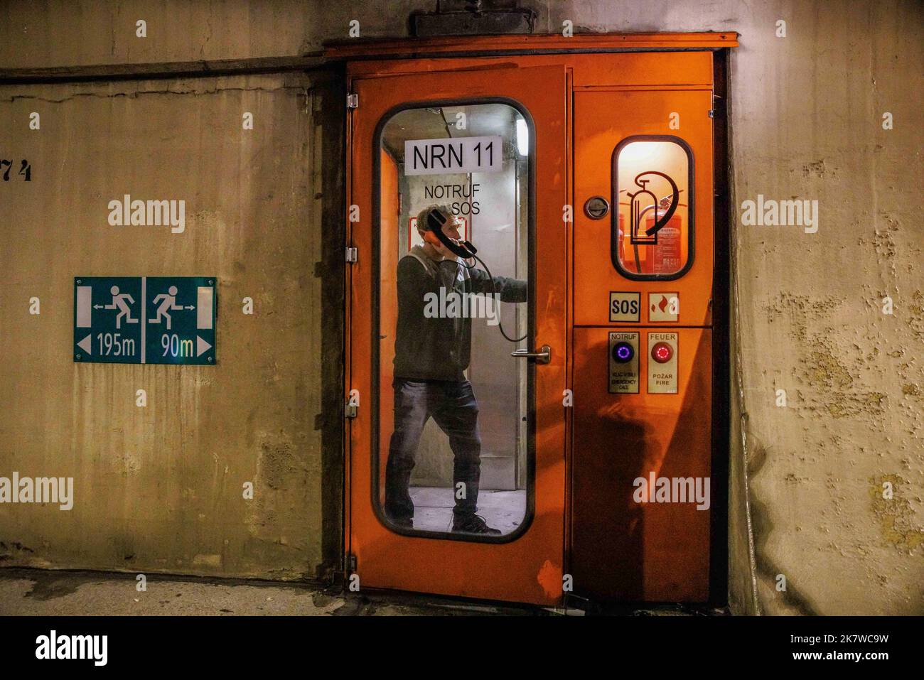 A participant uses the in-tunnel emergency phone booth to call ...