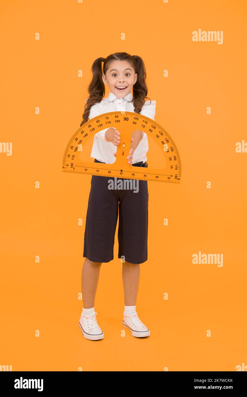 Engineering course. Geometry concept. Schoolgirl holding protractor for ...