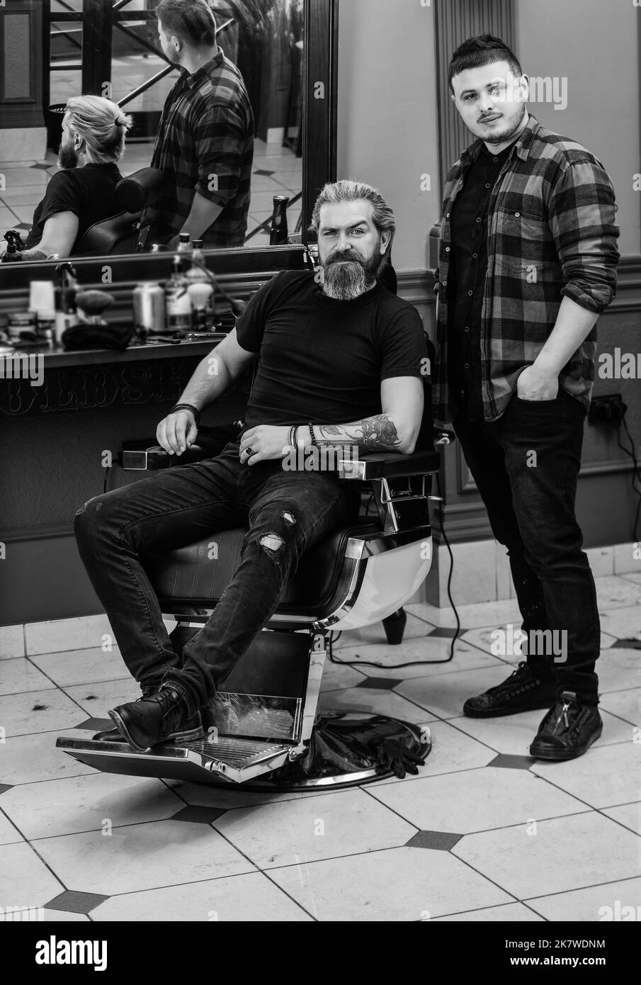 hair cut and beard care for caucasian guy in barbershop, stylist Stock ...