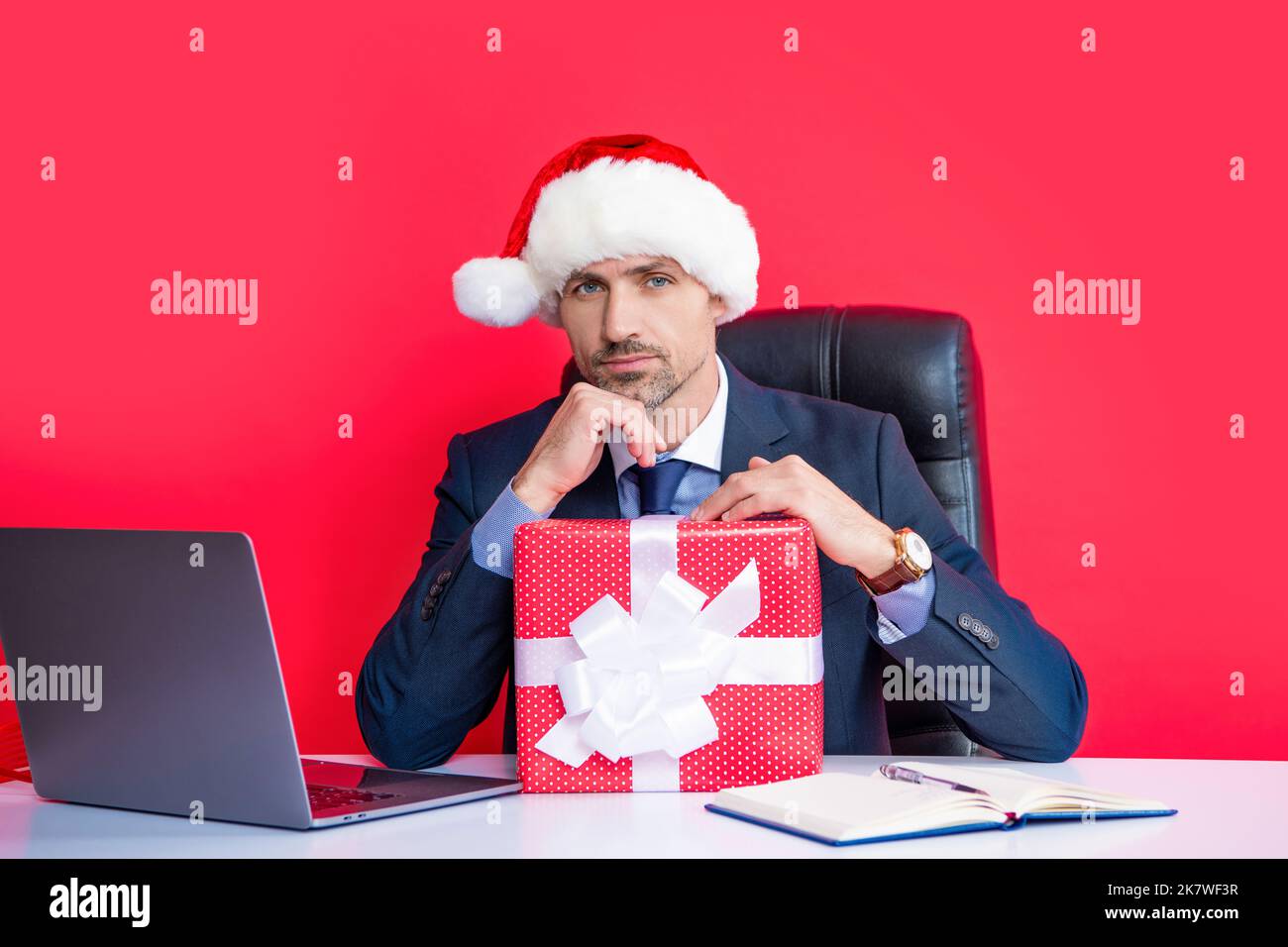 mature boss wear red santa claus hat and party glasses hold gift box ...