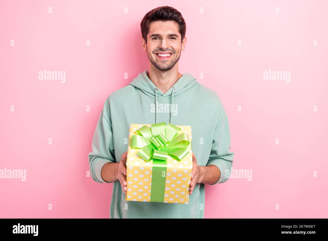 Photo of satisfied glad person toothy smile arms hold giftbox isolated ...