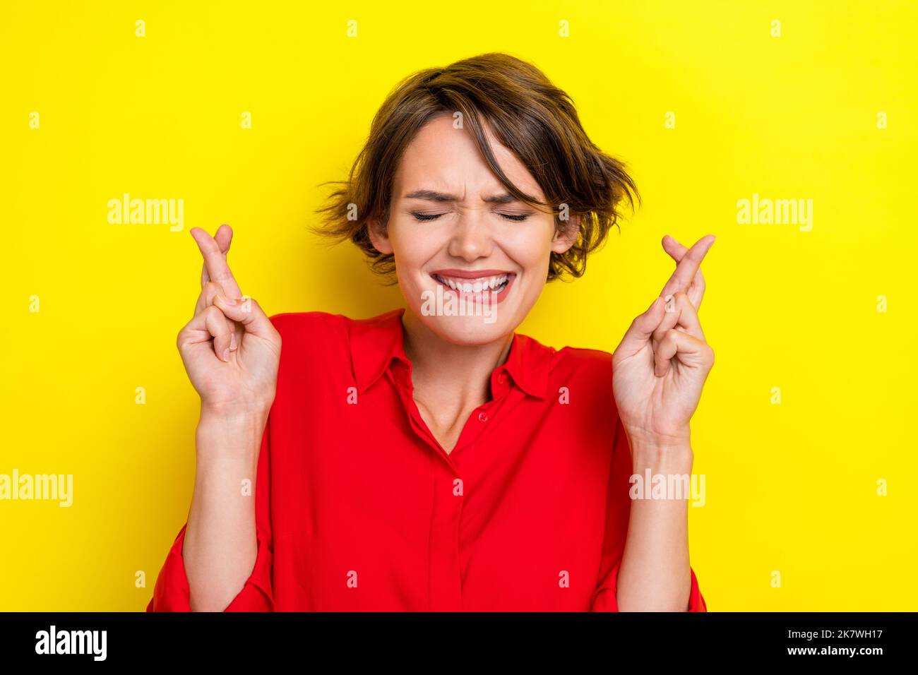 Photo of worried girl closed eyes biting lips crossed fingers isolated ...