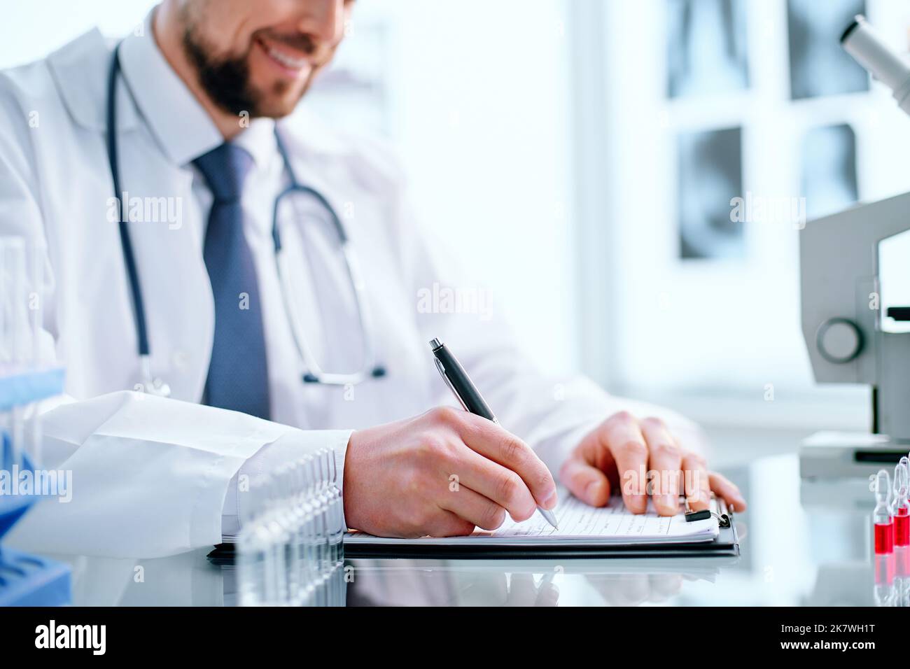Doctor writes medical journal notes hi-res stock photography and images ...