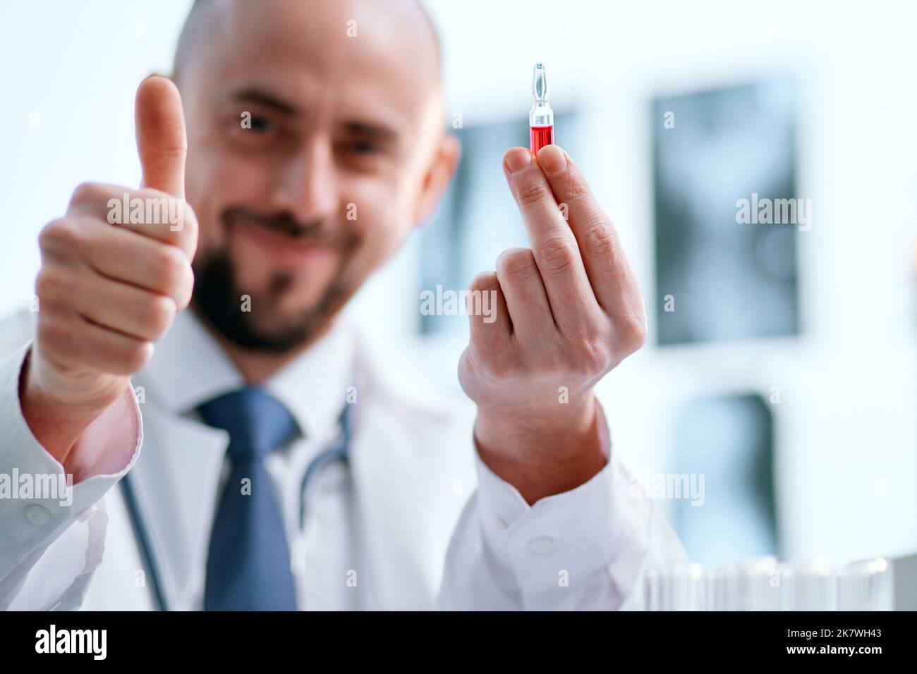 happy scientist with an ampoule of vaccine giving a thumbs up Stock ...