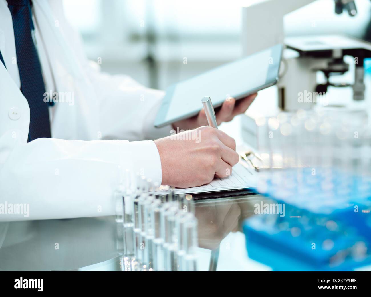 science lab technician with a digital tablet making notes on the ...