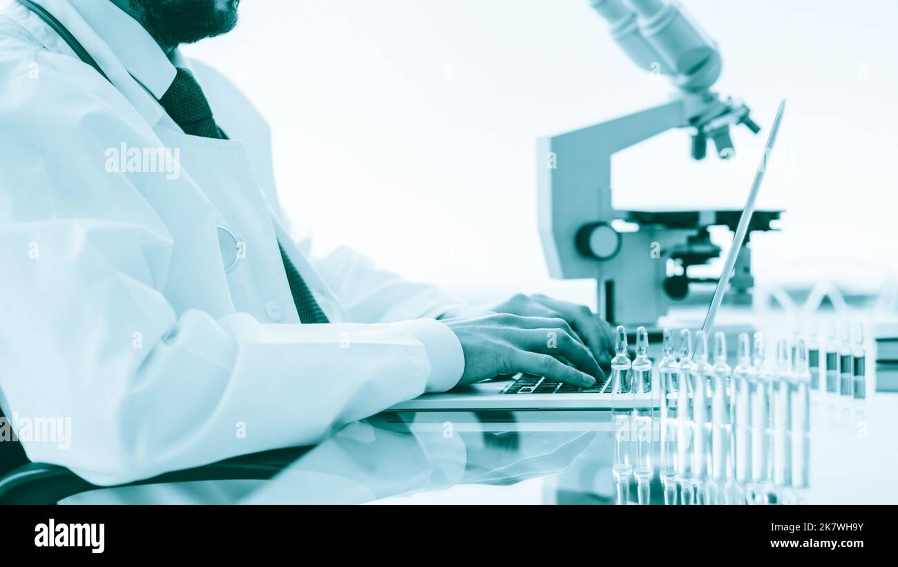 scientist works on a laptop in a medical laboratory Stock Photo - Alamy