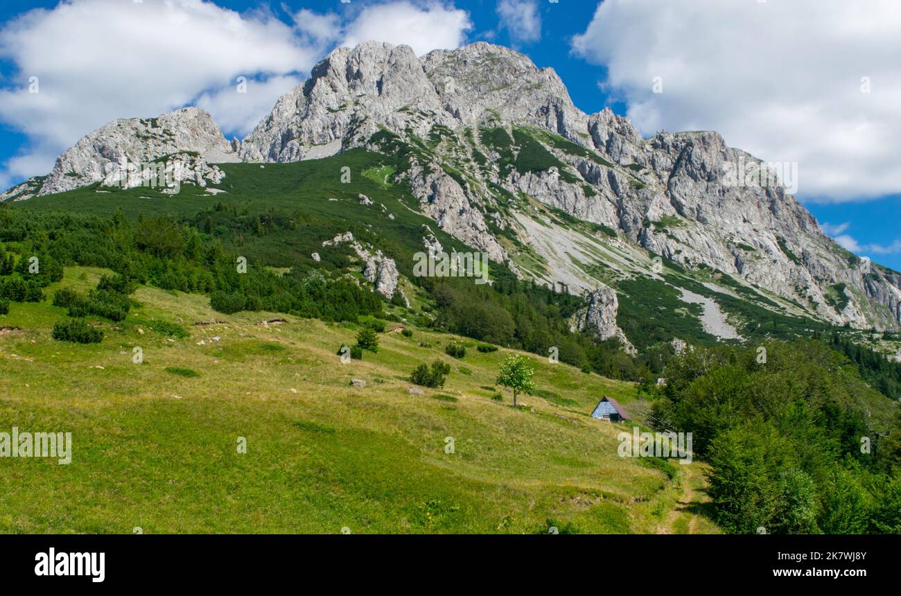 Mountain hut underneath of a mountain peak Stock Photo - Alamy