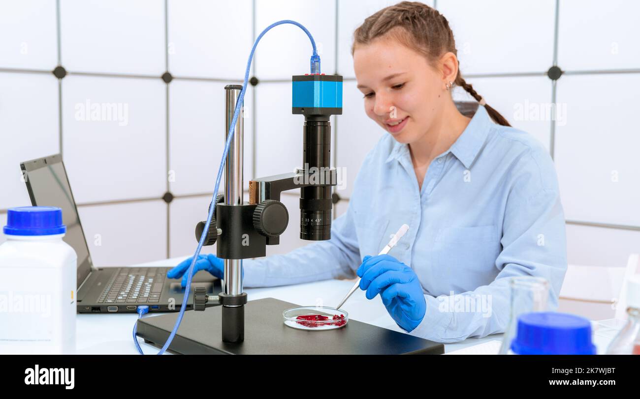 young woman scientist in crystallography laboratory studying crystals ...