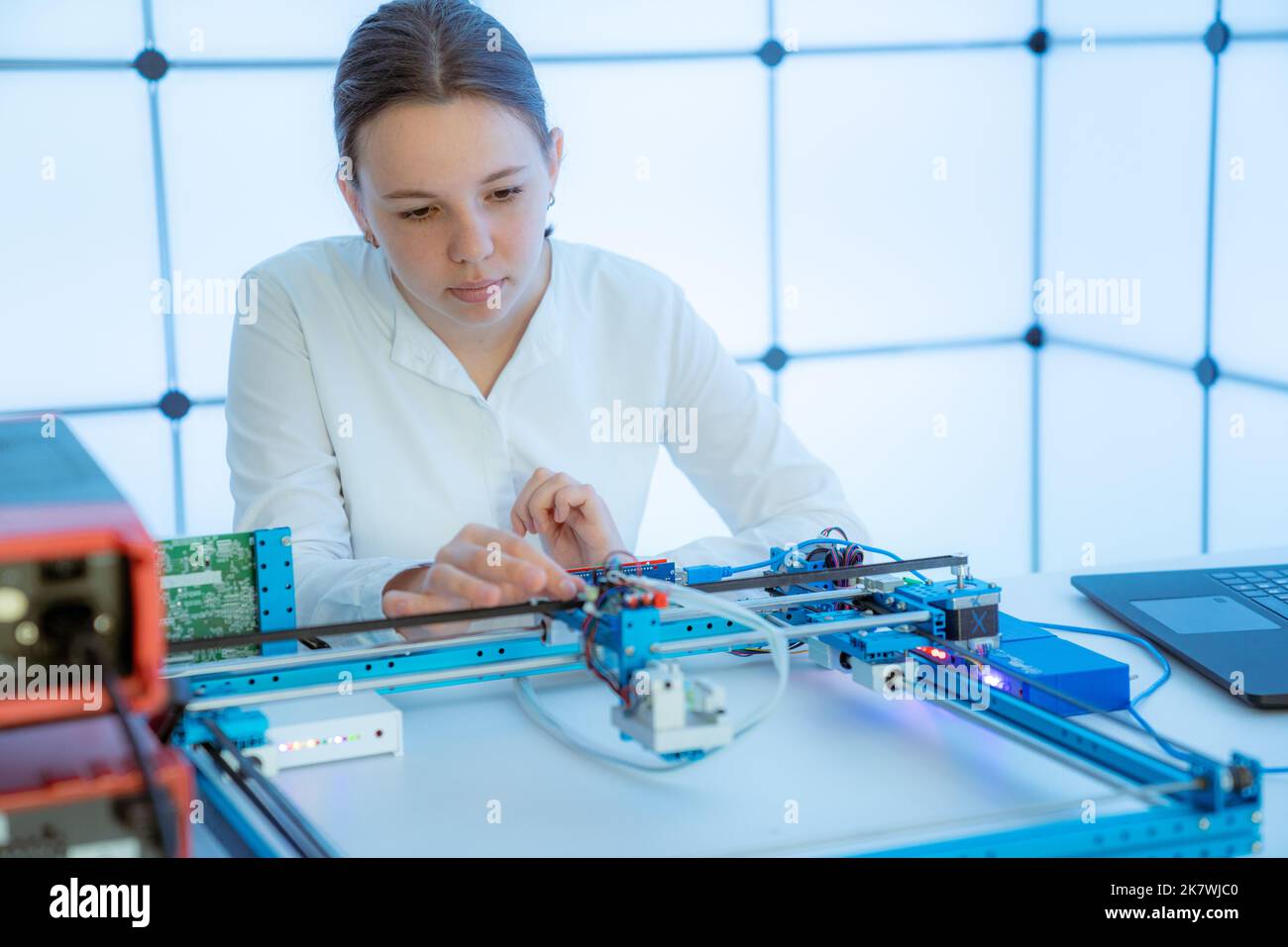 Student girl in the University Automation Laboratory sets up a model of ...