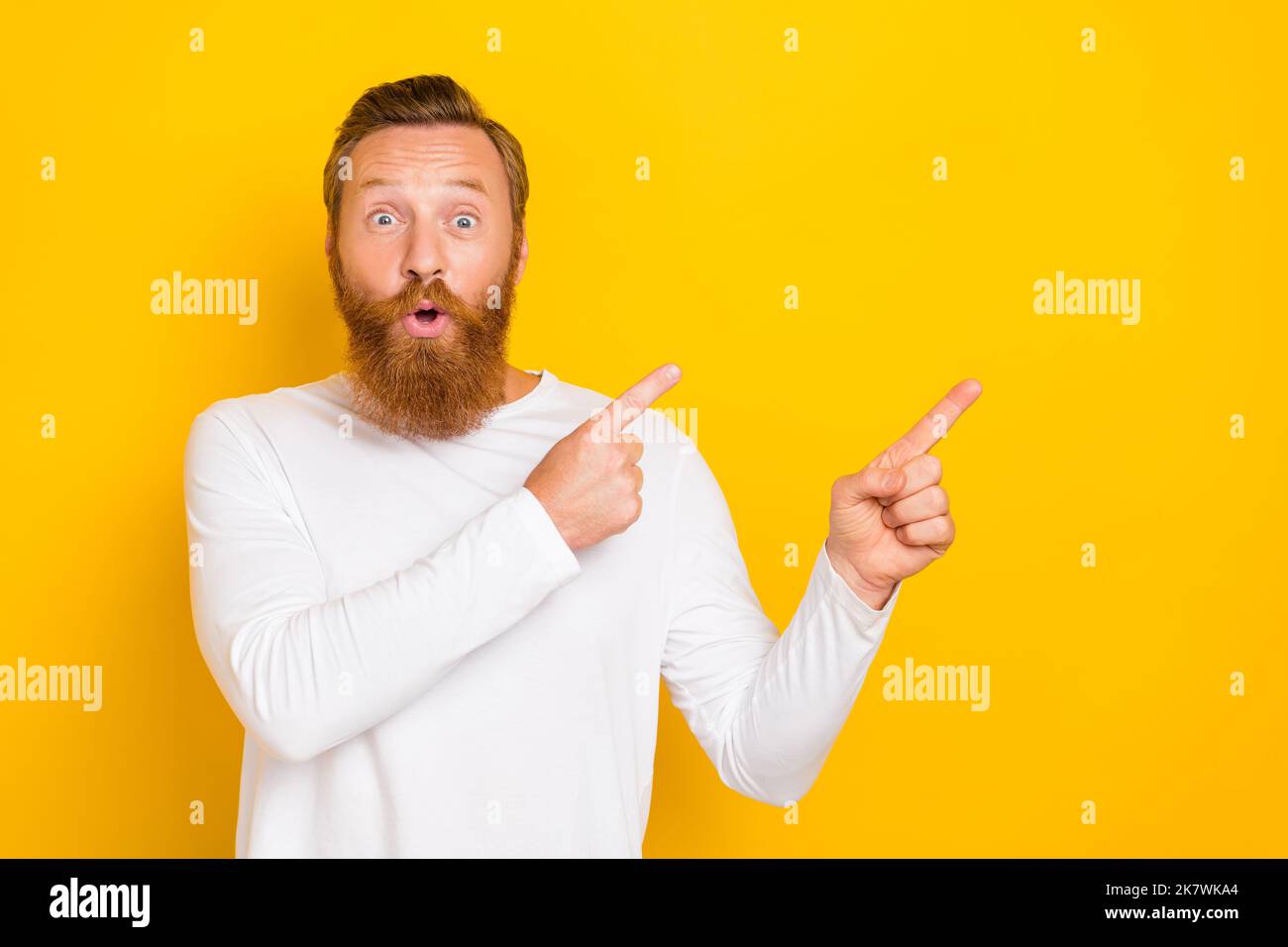 Photo of young handsome redhair omg wow reaction finger pointing empty ...