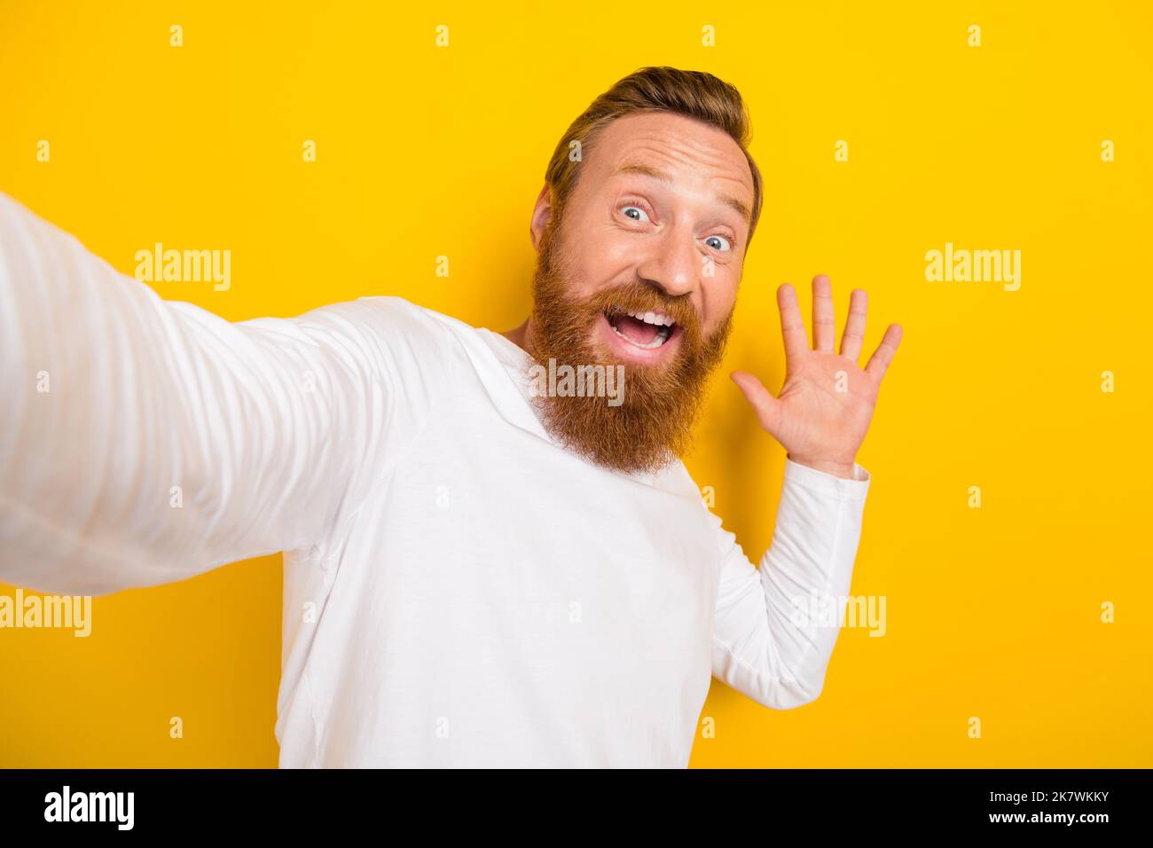 Photo portrait of handsome young man make selfie front camera wave hand ...