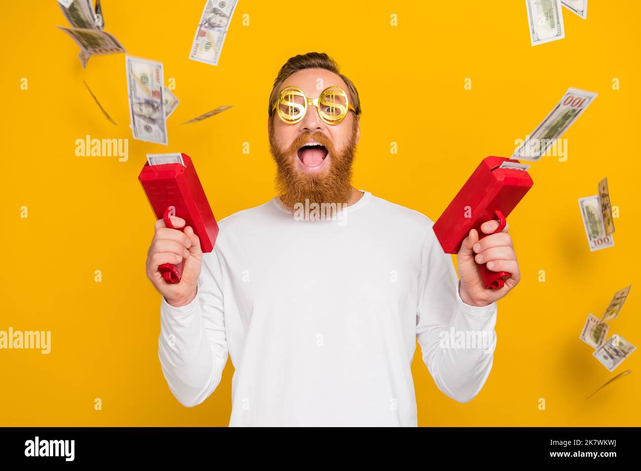 Photo of cool beard orange hair man shoot money gun wear dollar eyewear white shirt isolated on ...