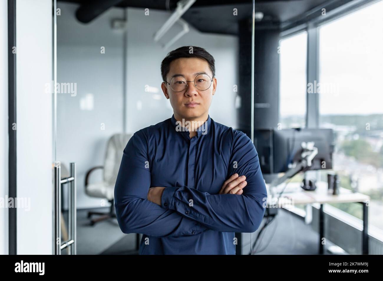 Portrait of serious Asian developer, businessman with crossed arms ...