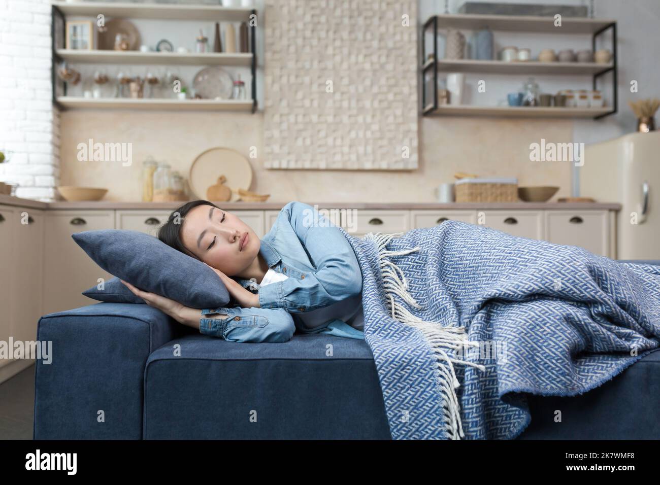 Close-up photo of a young beautiful Asian woman sleeping at home lying ...