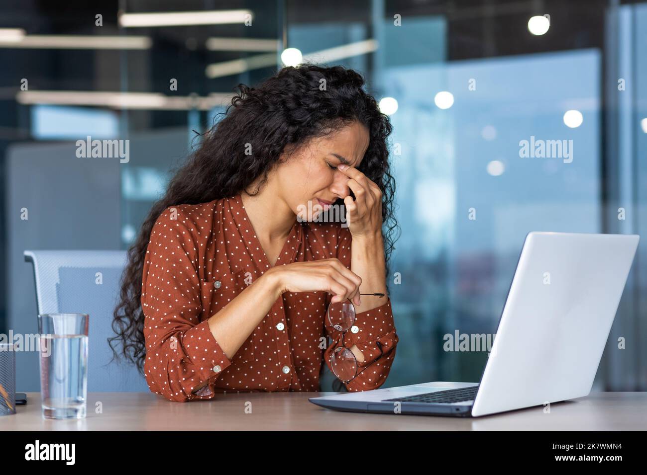 Tired business woman working inside modern office building, worker ...