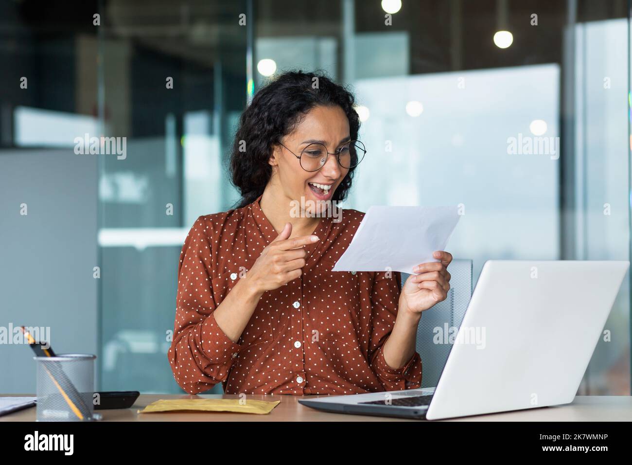 Businesswoman received happy news letter from bank, Hispanic woman with ...