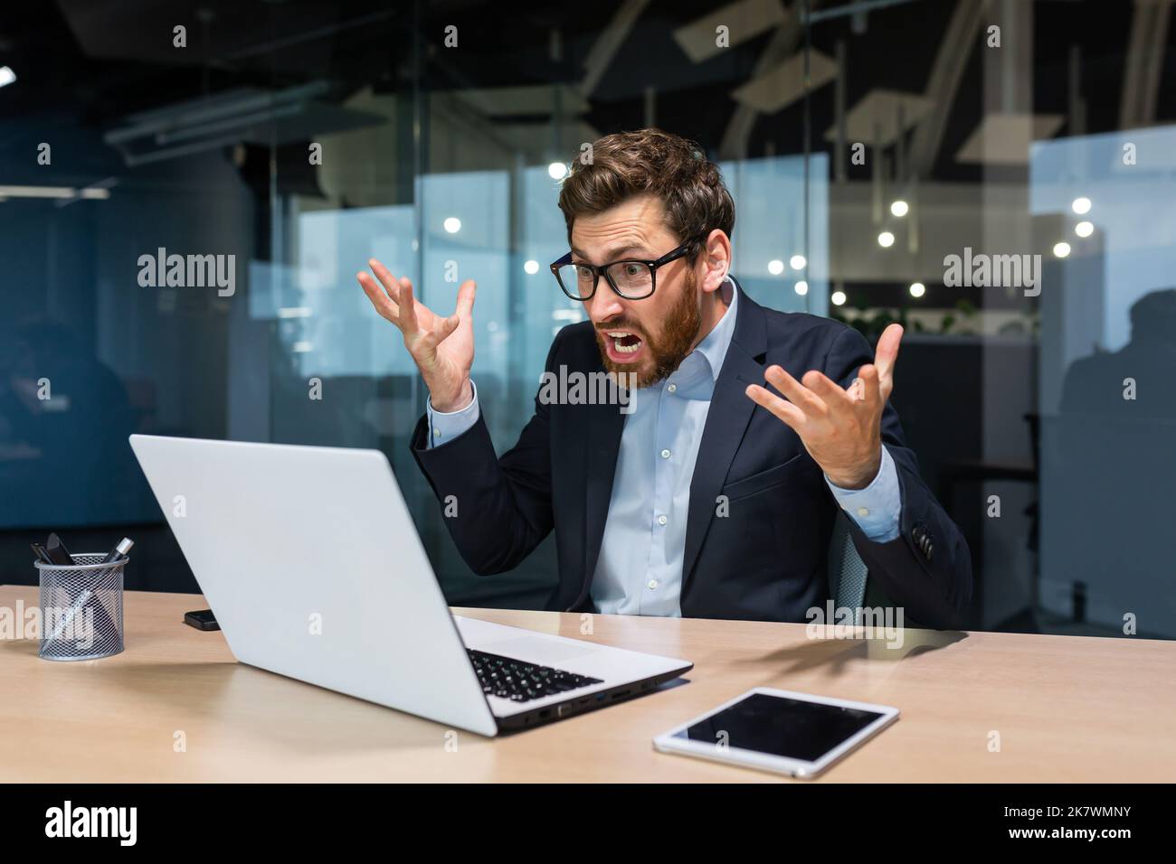 Angry and angry businessman talking on video call, talking to ...