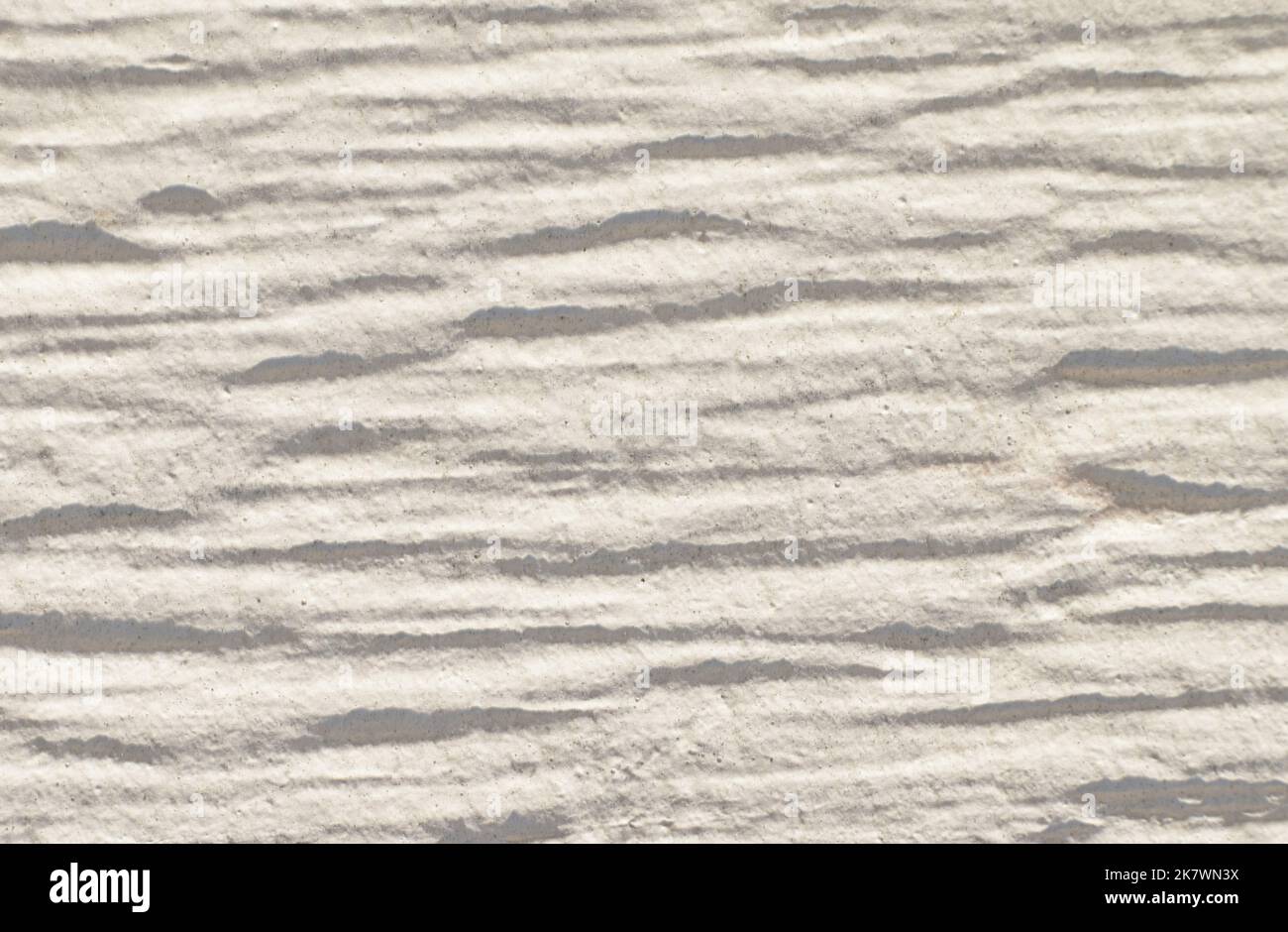 White rugged painted wooden wall with rough textures and shadows. Plain ...