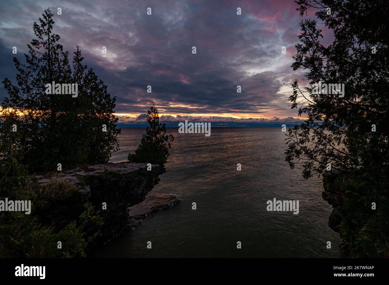 Sunrise lights up the Lake Michigan shore at Cave Poimt County Park ...