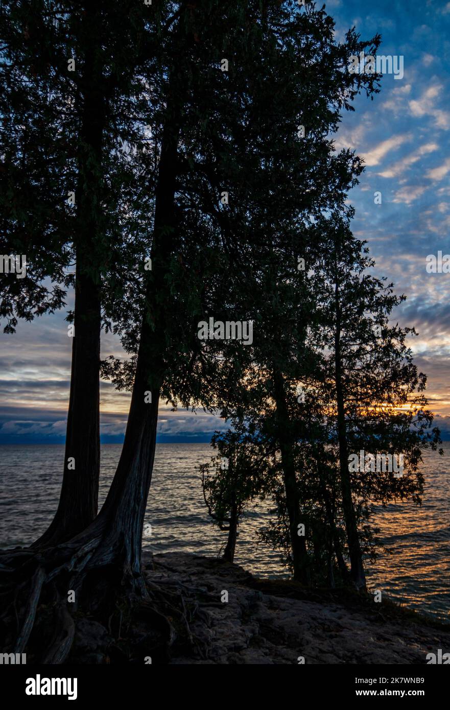 The sun rises out of a cloud bank over Lake Michigan as seen from Cave ...
