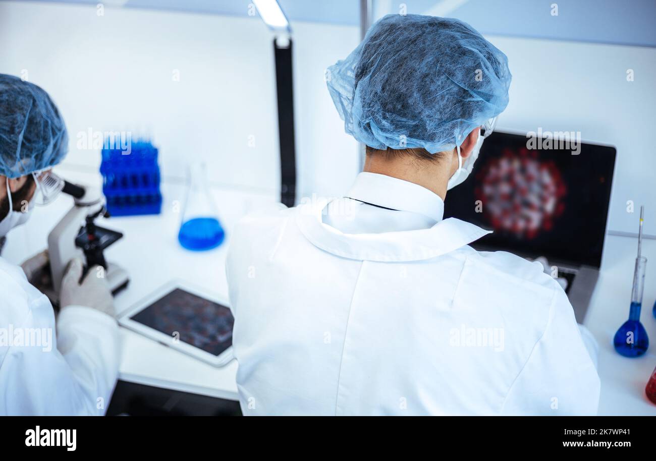rear view. scientist sitting at a Desk in the laboratory Stock Photo ...