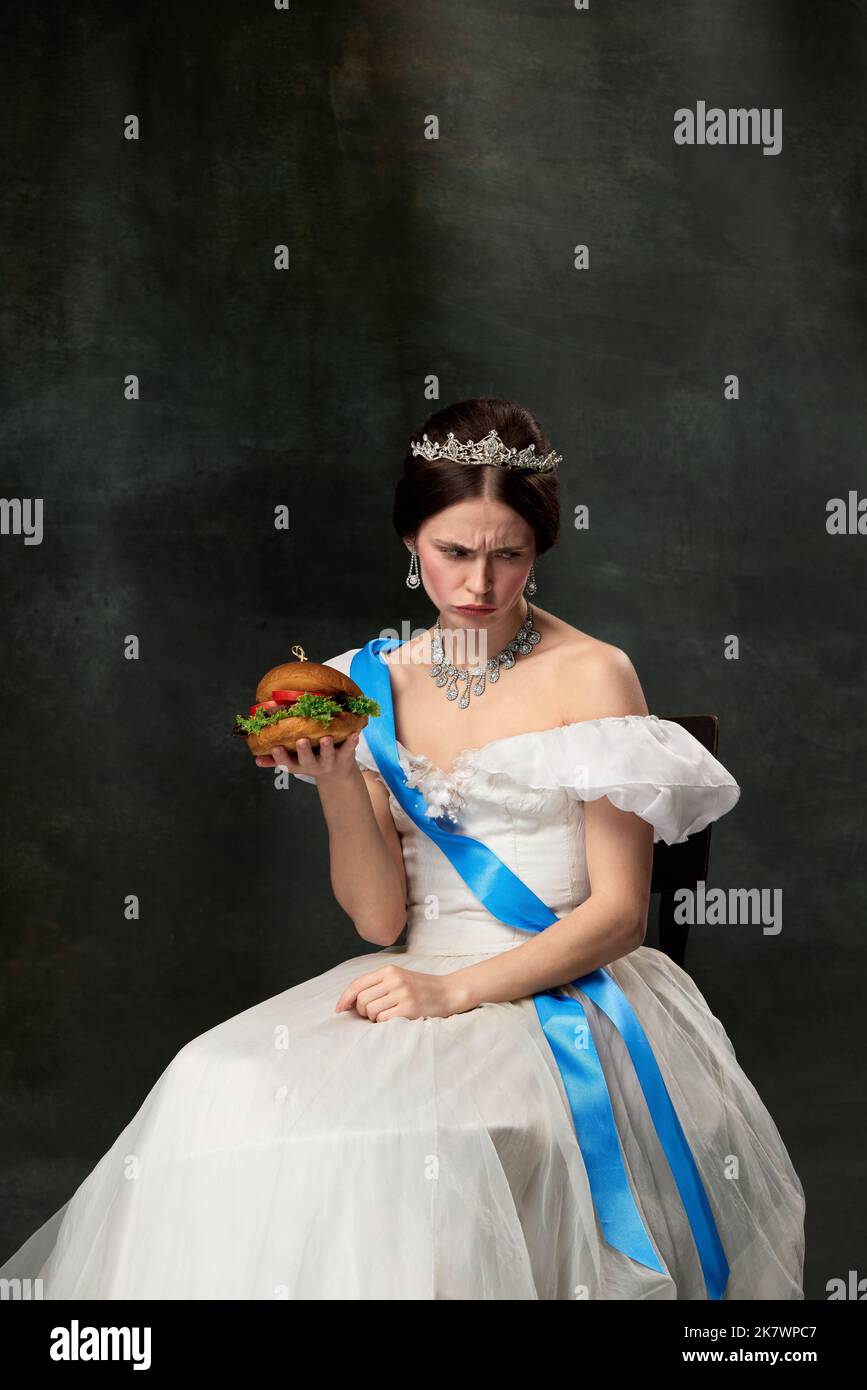 Sadness. Young beautiful woman in image of queen or princess in white ...