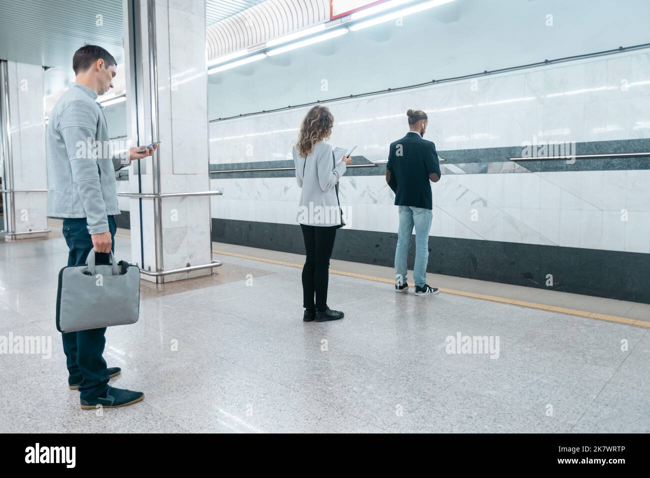 various subway passengers waiting for the train on the platform Stock ...