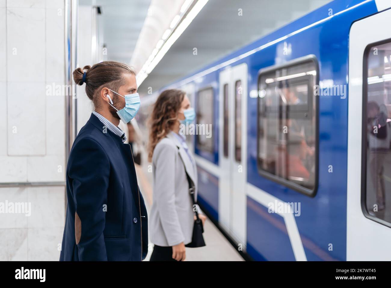 metro passengers standing at a safe distance on the platform Stock ...