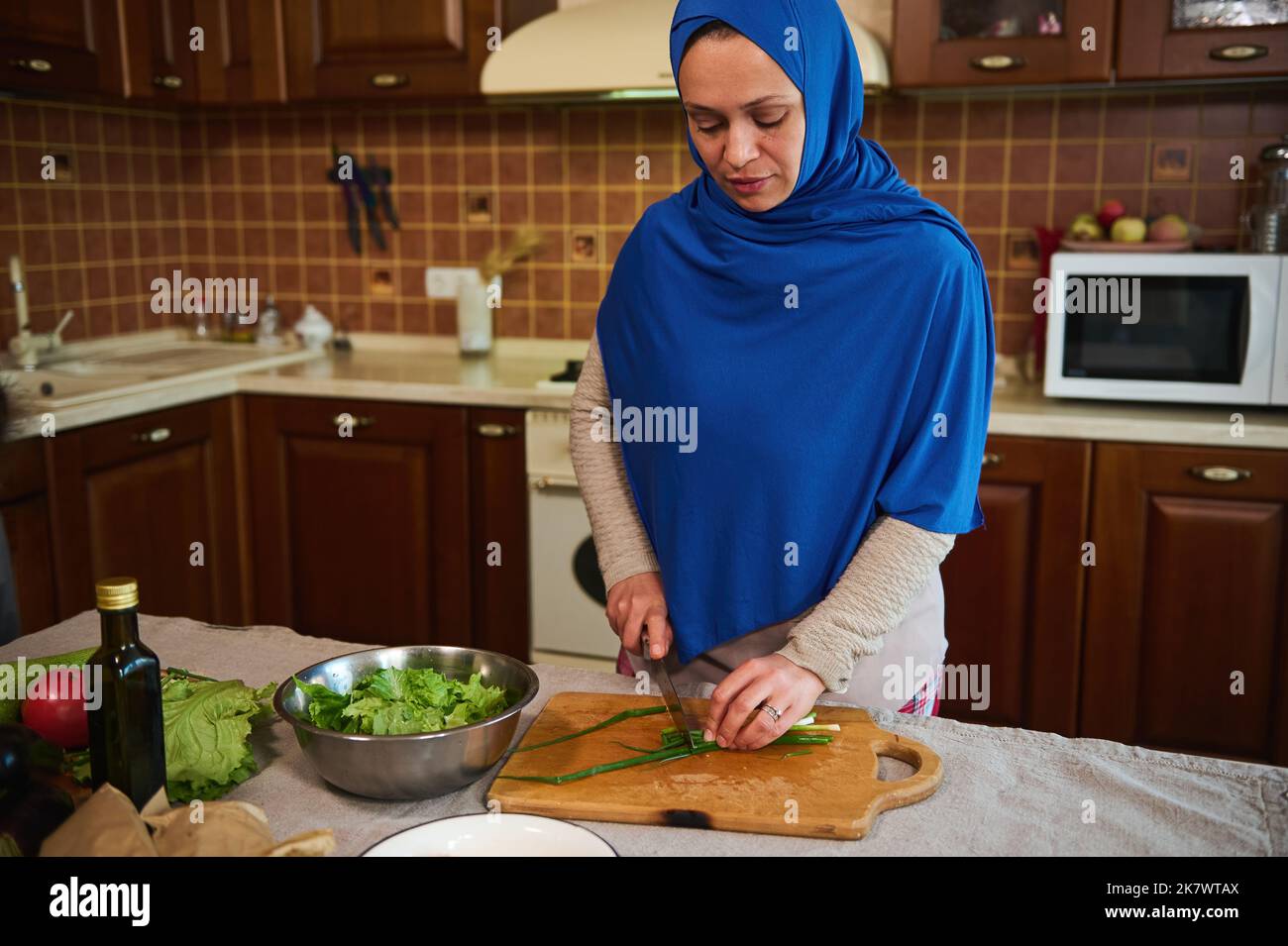 Arabic Muslim pretty woman housewife in hijab, cooking delicious and ...