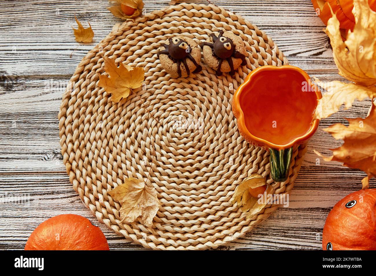 Funny Halloween mock up with spider cookies and cup of tea in shape of ...