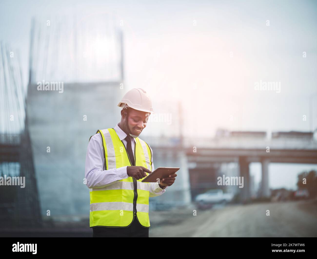 African civil engineer working with use tablet for control the road ...