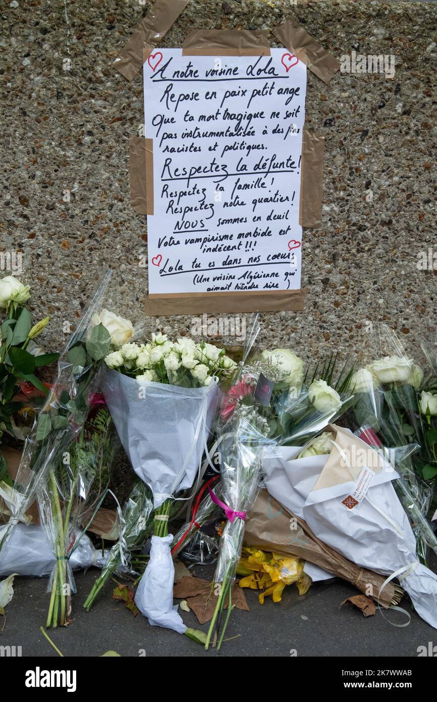 Flowers, messages and candles are seen in front of the building where ...