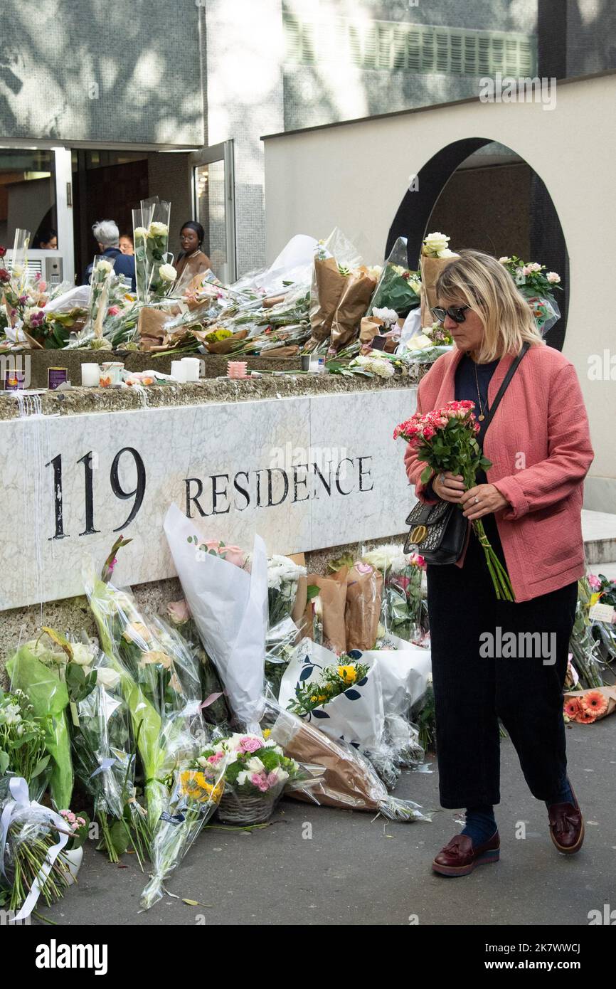 Flowers, messages and candles are seen in front of the building where ...