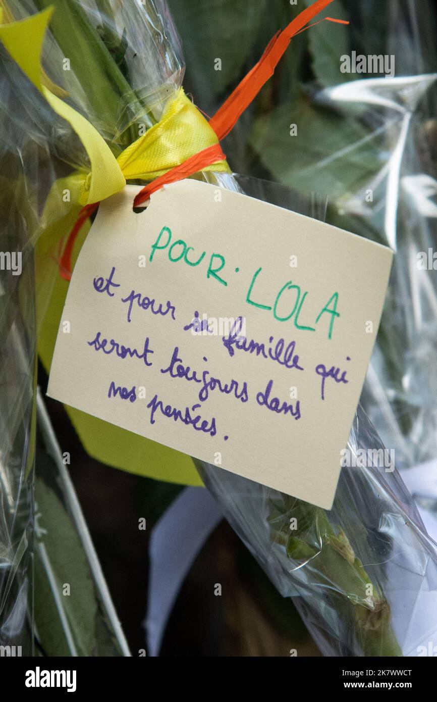 Flowers, messages and candles are seen in front of the building where ...