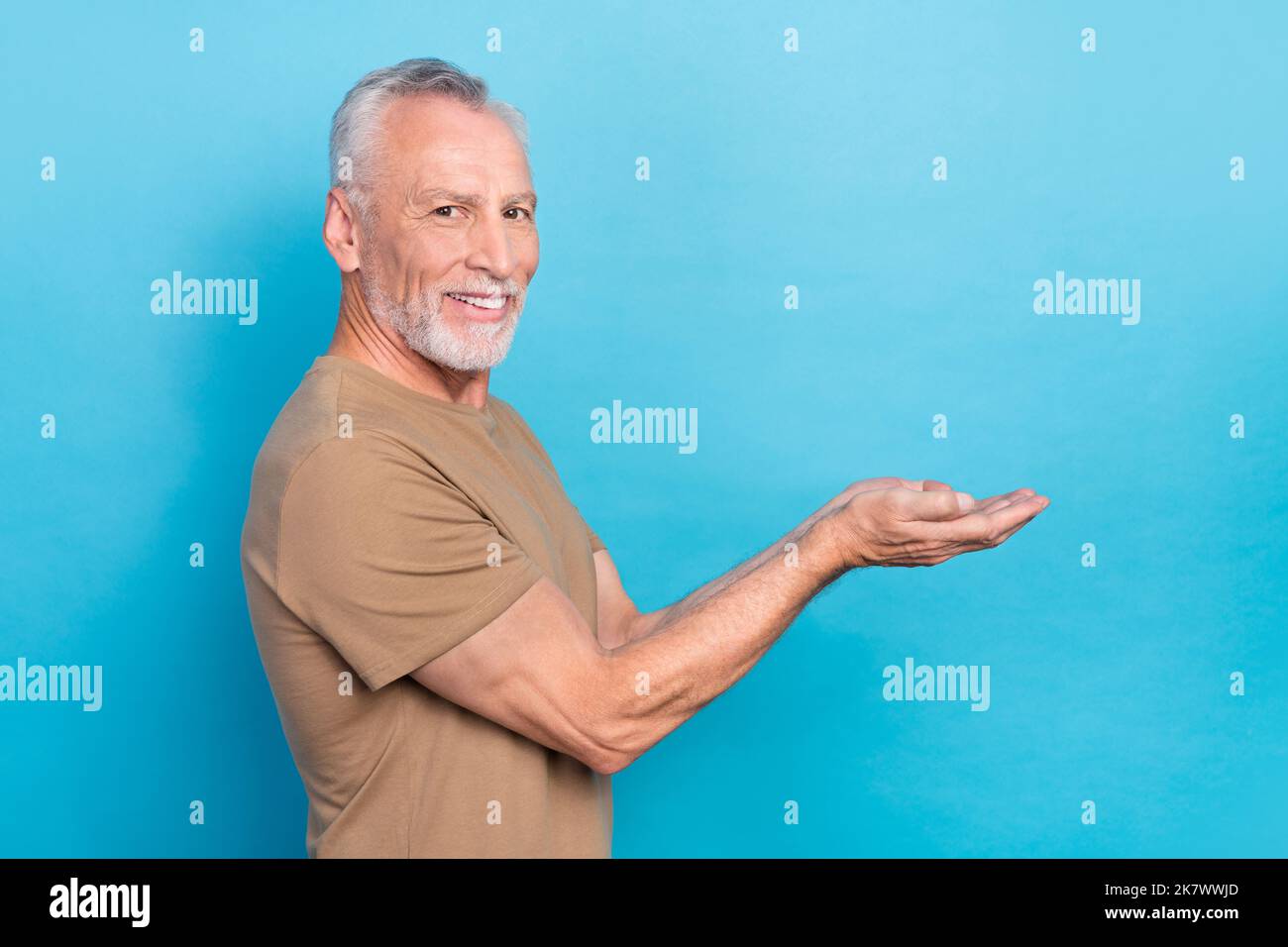 Portrait of satisfied retired man gray hair beard dressed beige t-shirt ...