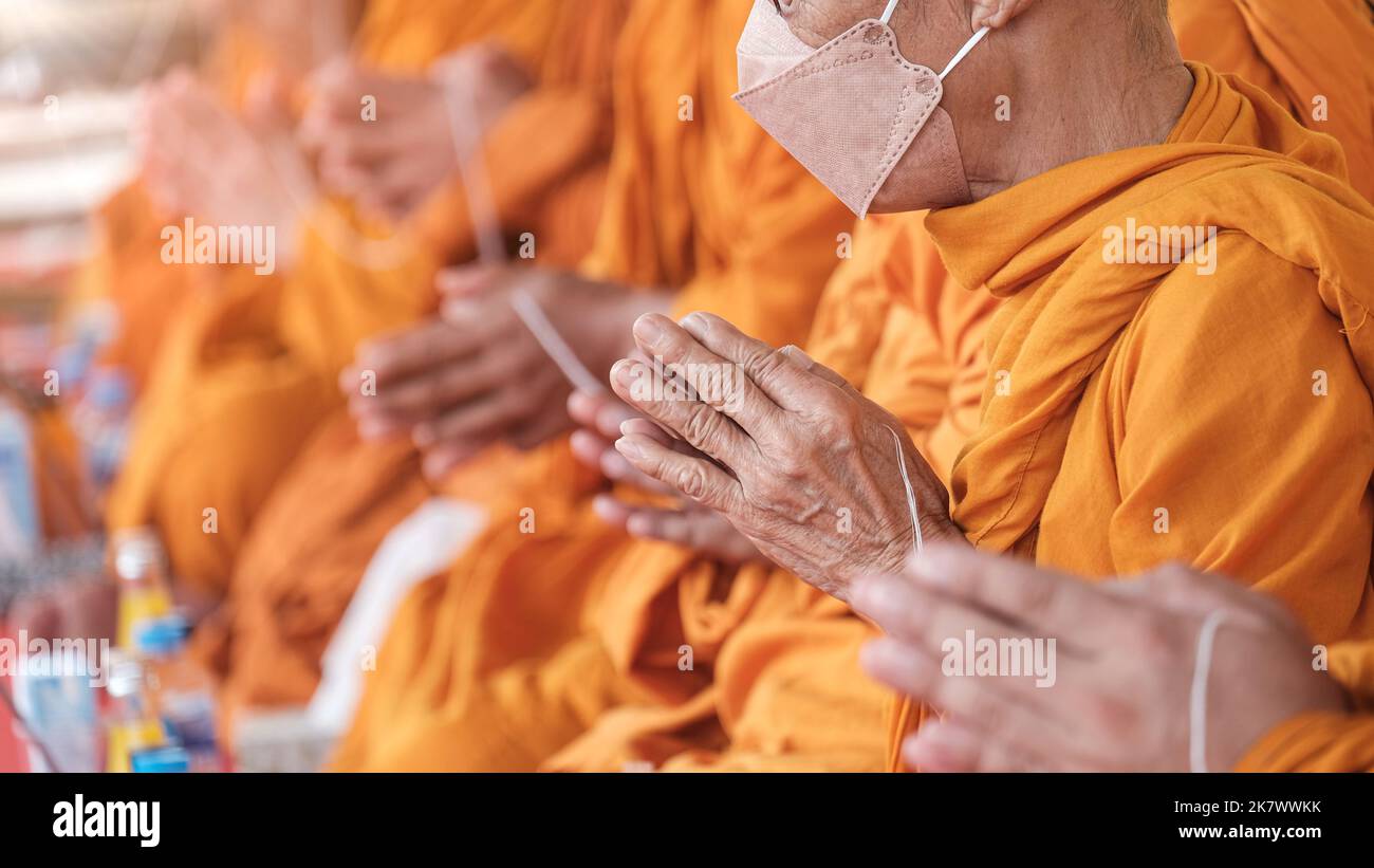 Monks in mask pray and pay respect to Buddhist ceremonies Stock Photo ...