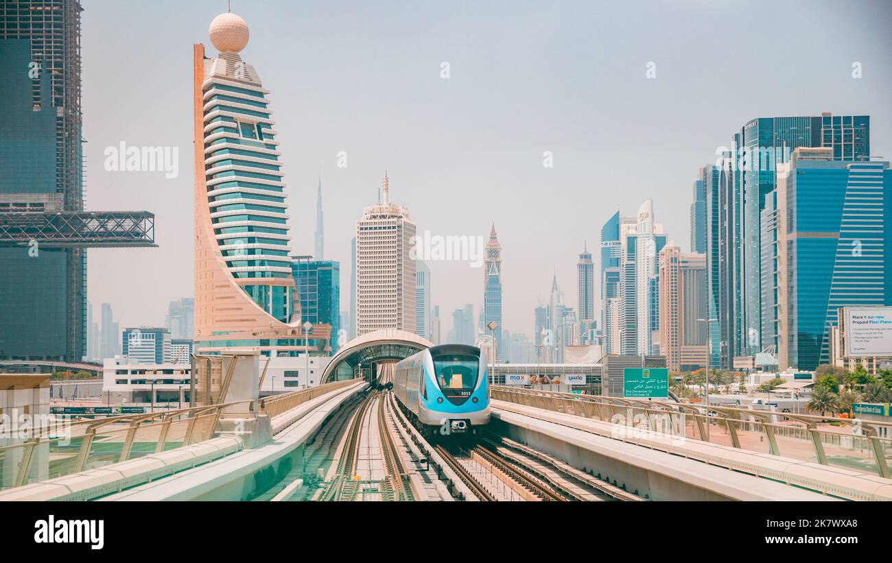 Monorail Subway train rides among glass skyscrapers in Dubai. Traffic ...