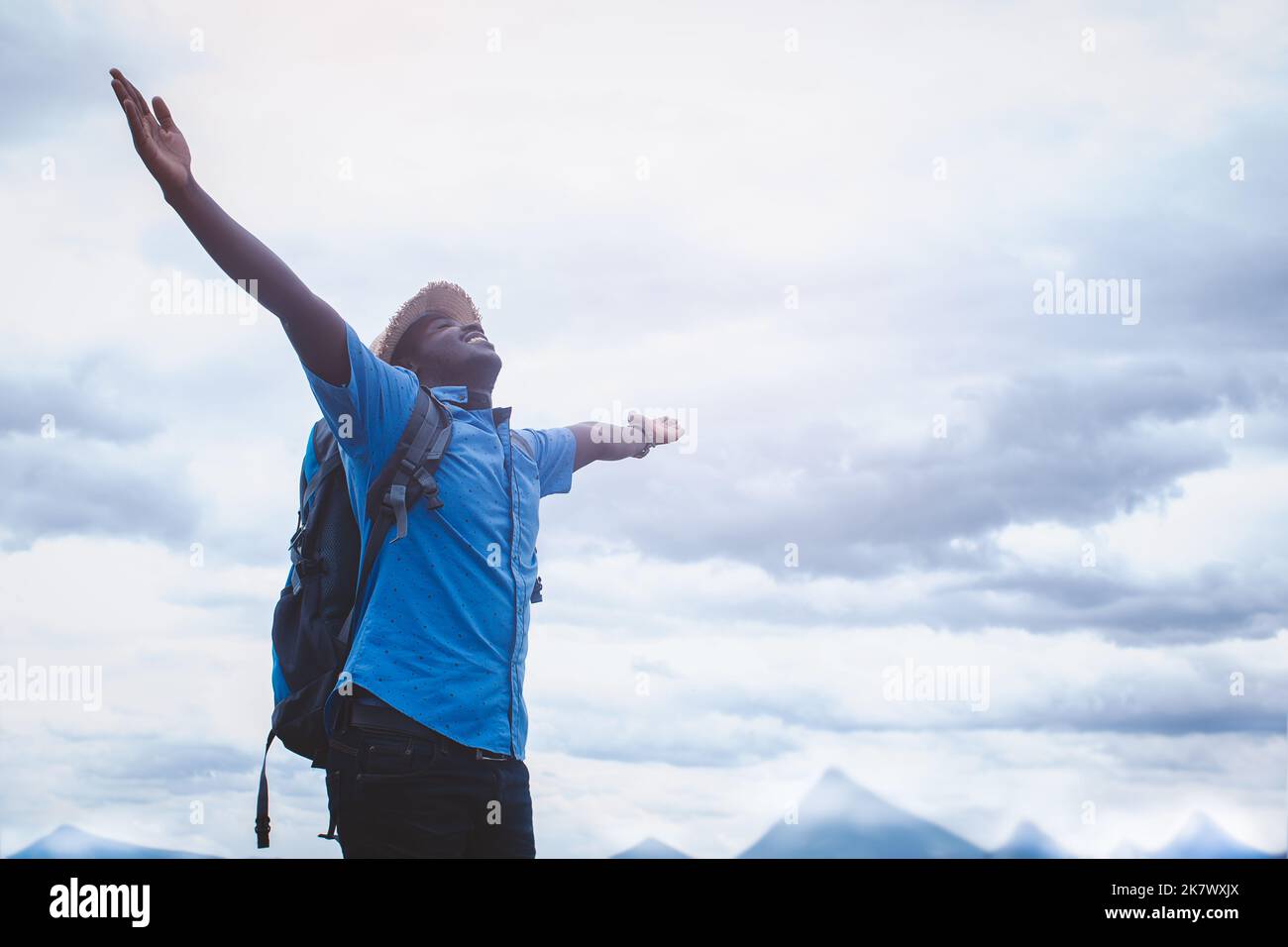 African traveler man with backpack enjoying the view in nature.Freedom ...