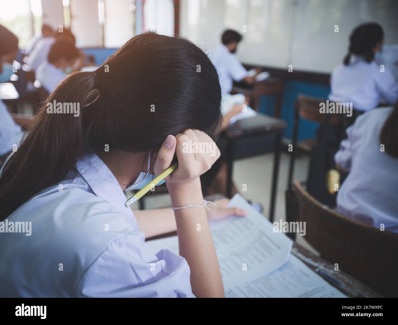 Students reading exam answer sheets exercises in classroom of school ...