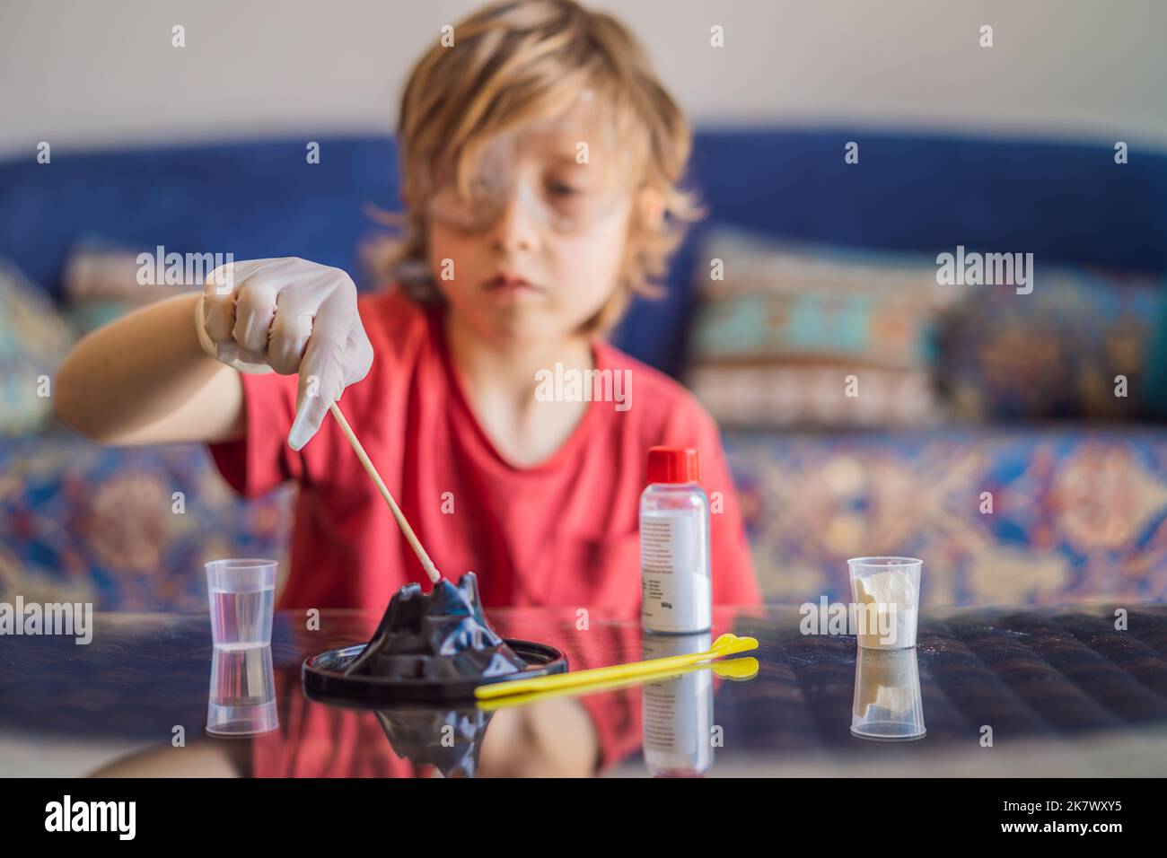 Kid boy doing chemical experiment at home. Child with protective ...