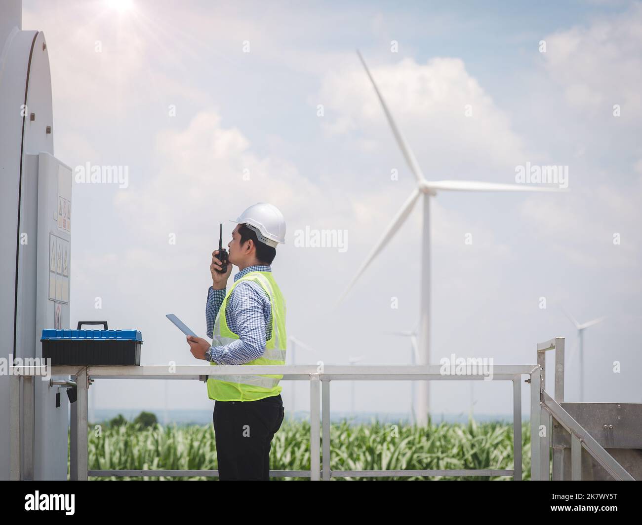 Engineer man is using a tablet to control and monitor the operation of ...