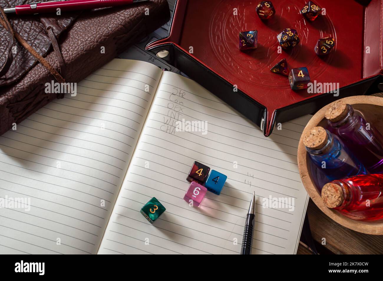 Overhead image of colorful regular dice on a note book used for rolling ...