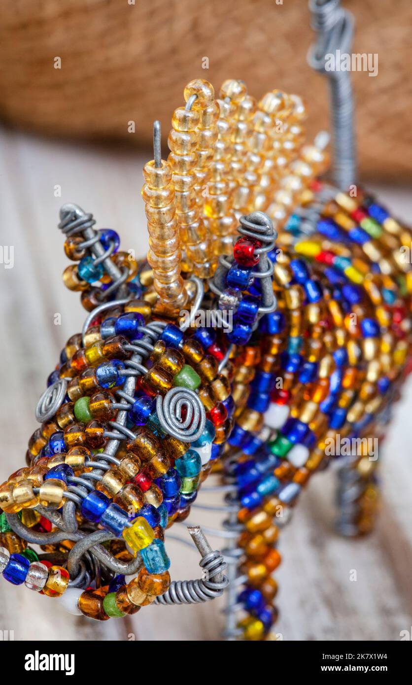 colorful South African beaded craft of warthog on rustic surface with ...