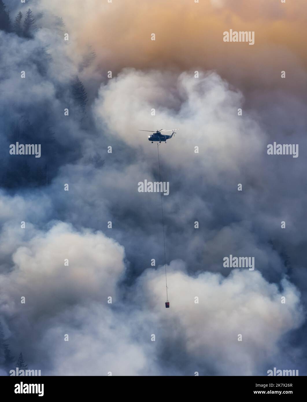 Wildfire Service Helicopter flying over BC Forest Fire and Smoke on the ...