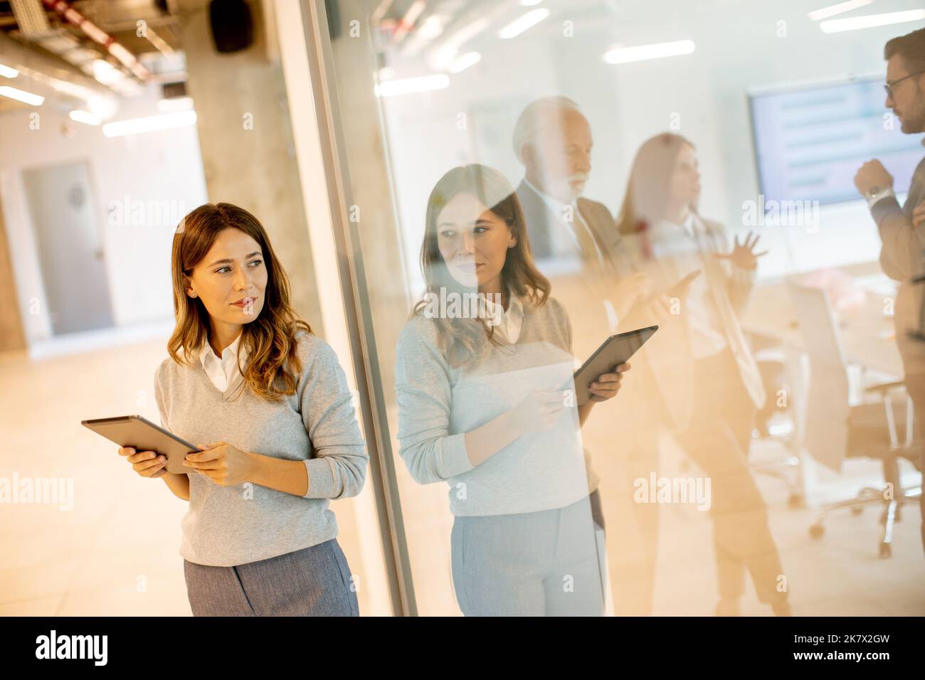 Pretty young woman with digital tablet in the office Stock Photo - Alamy