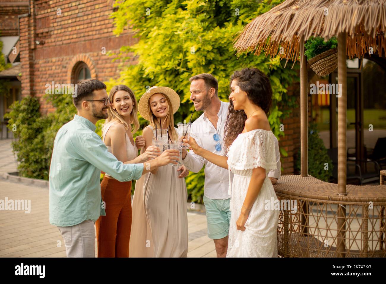 Group of happy young people cheering and having fun outdoors with ...