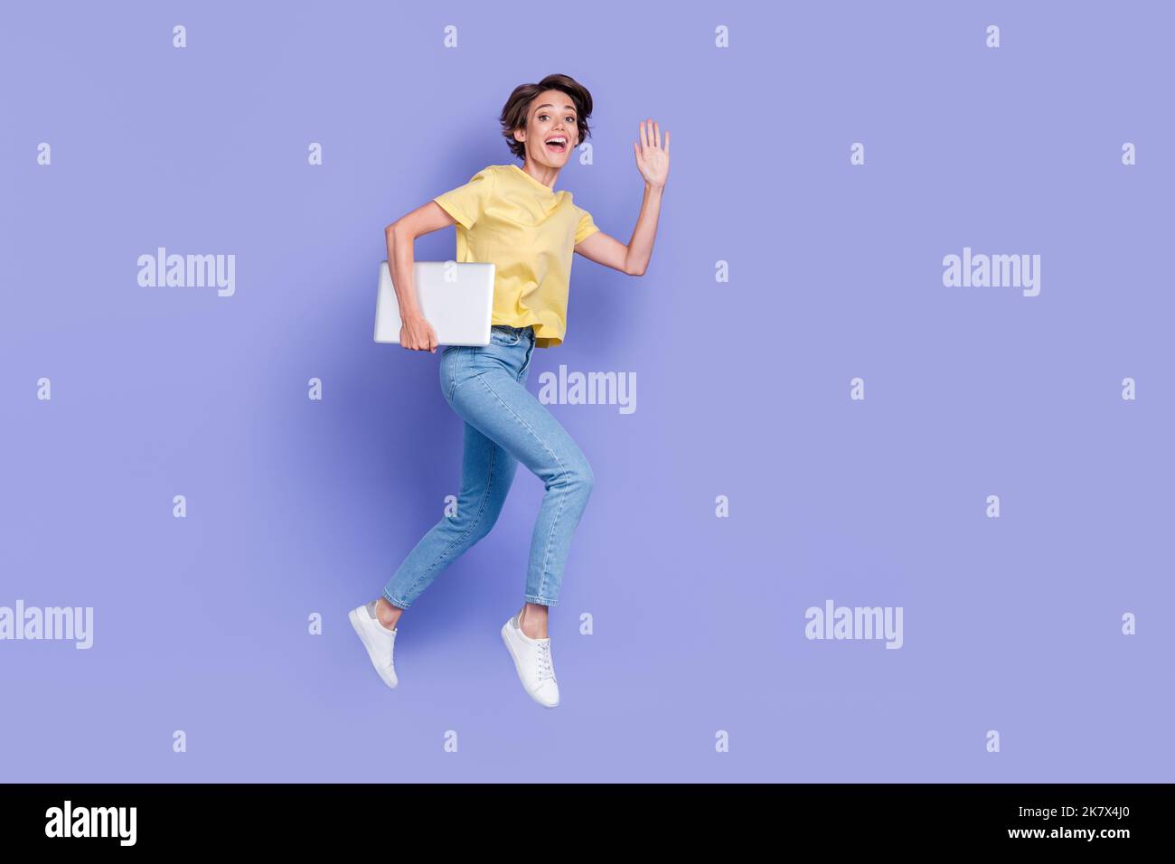 Full length portrait of crazy amazed person jump rush hold netbook arm ...