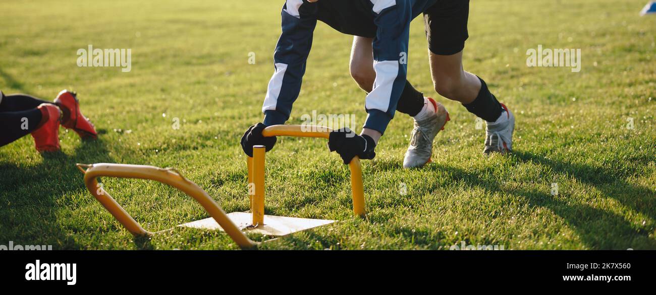 Teenage boy on football strengths training outdoor. Young boy pushing ...